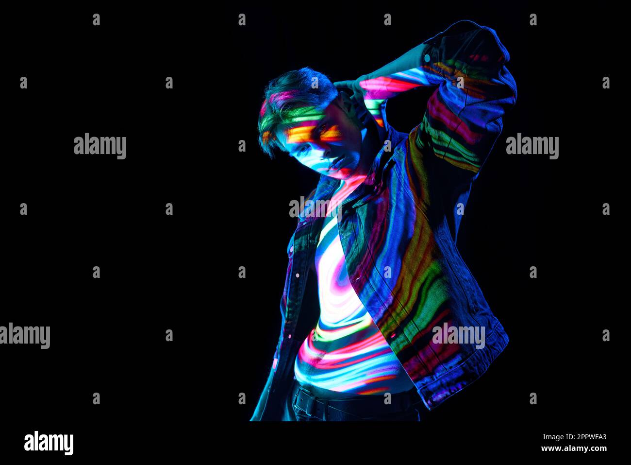 Handsome young male model posing with digital neon filter with ...