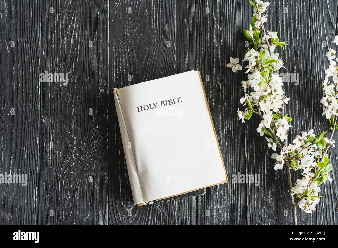 The Bible with spring flowers on a wooden background. Concept for faith ...