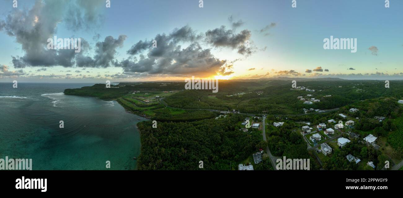 An aerial view of a coastal town at sunset. Pago Bay, Guam Stock Photo ...