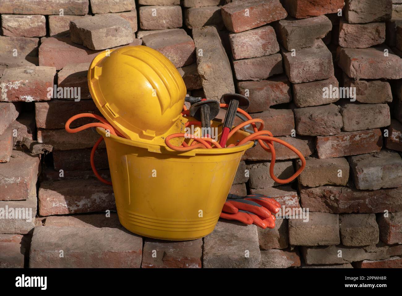work on construction sites, individual protection of helmet, hammer and ...