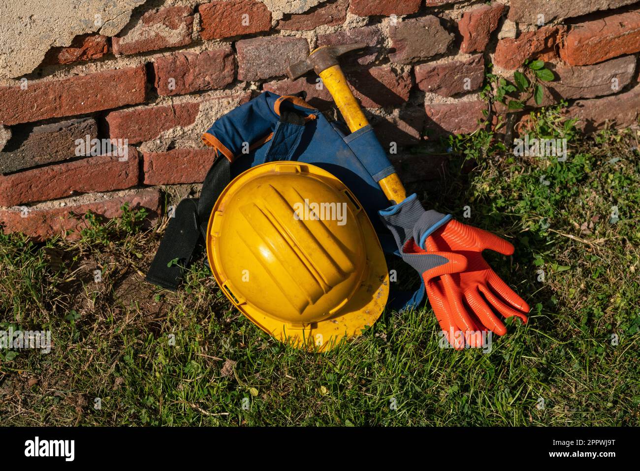 work on construction sites, individual protection of helmet, hammer and ...