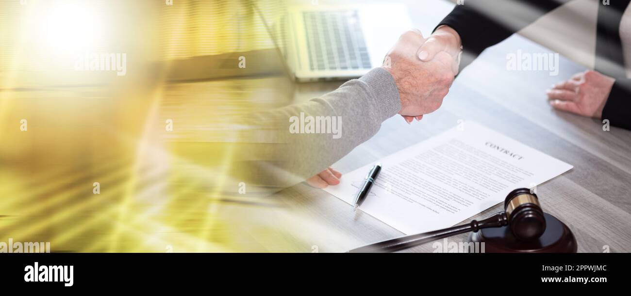 Handshake between female lawyer and male client after signing a ...