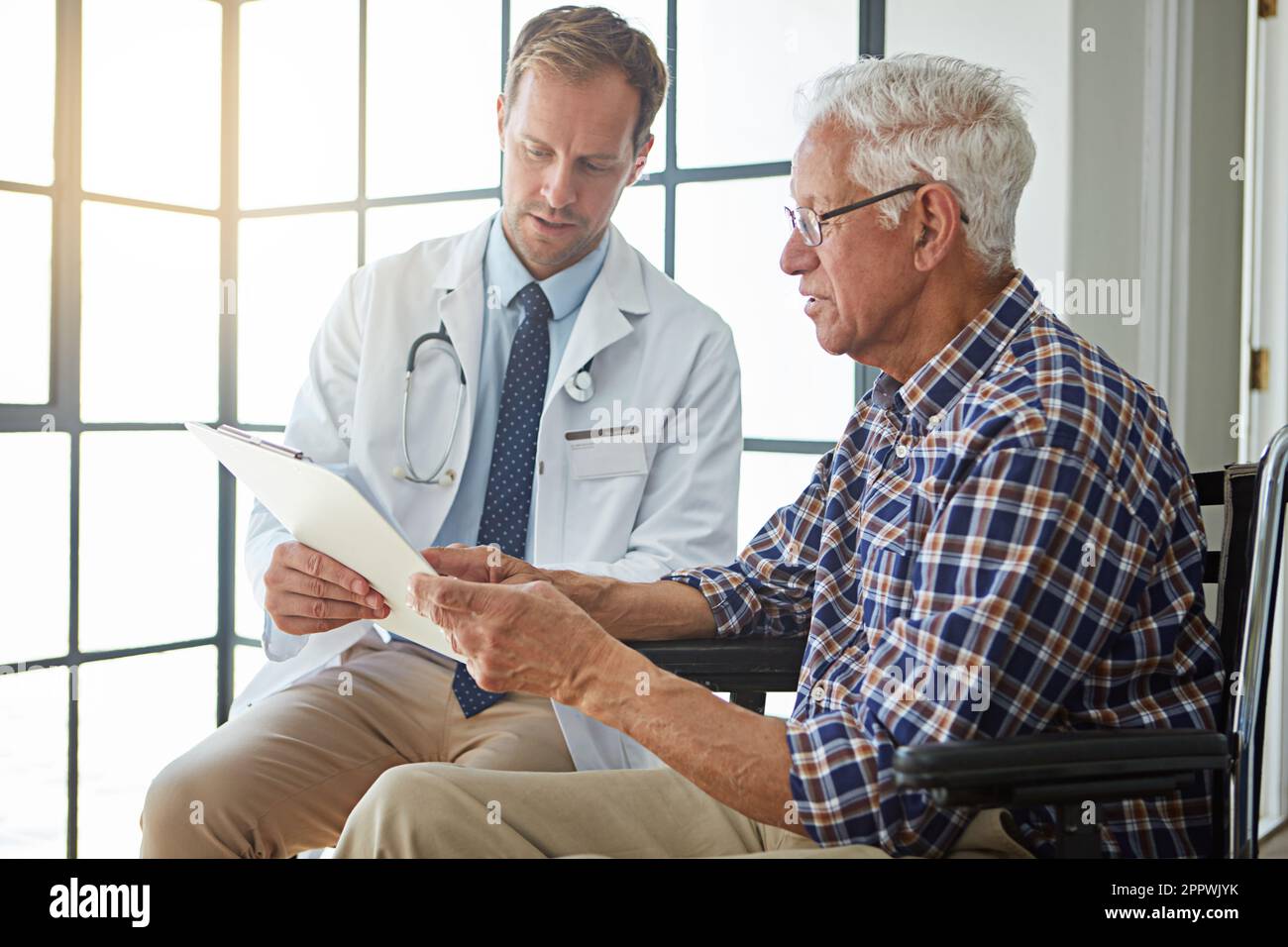 Heres the prognosis. a male doctor talking to a senior patient in the ...