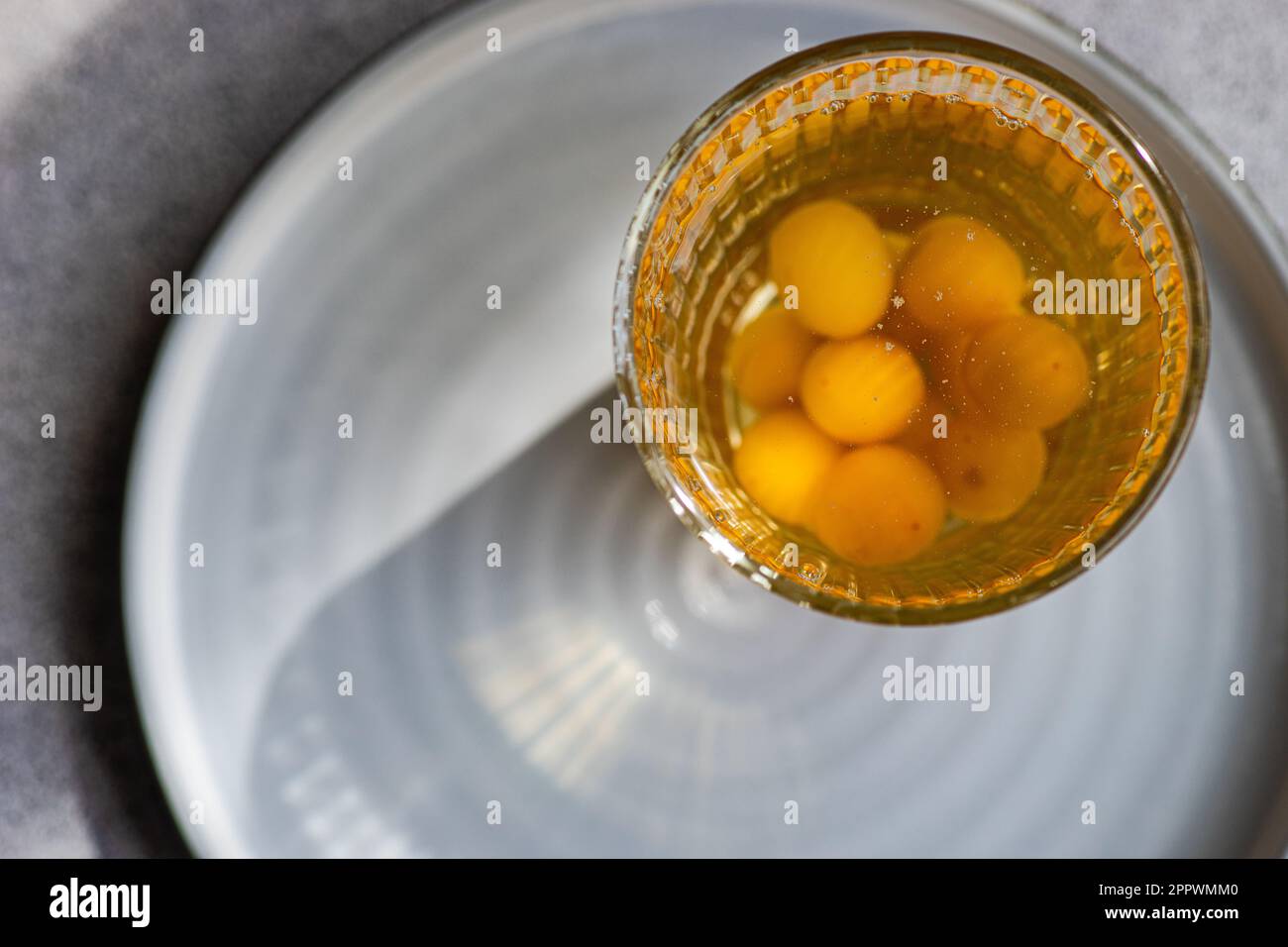 Overhead view of a cherry vodka cocktail on a plate Stock Photo - Alamy
