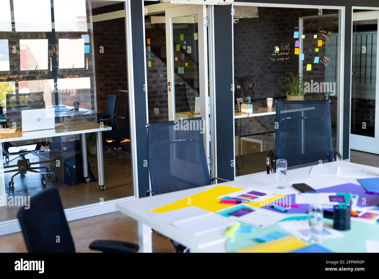 Busy table top at abandoned design meeting in creative office space ...