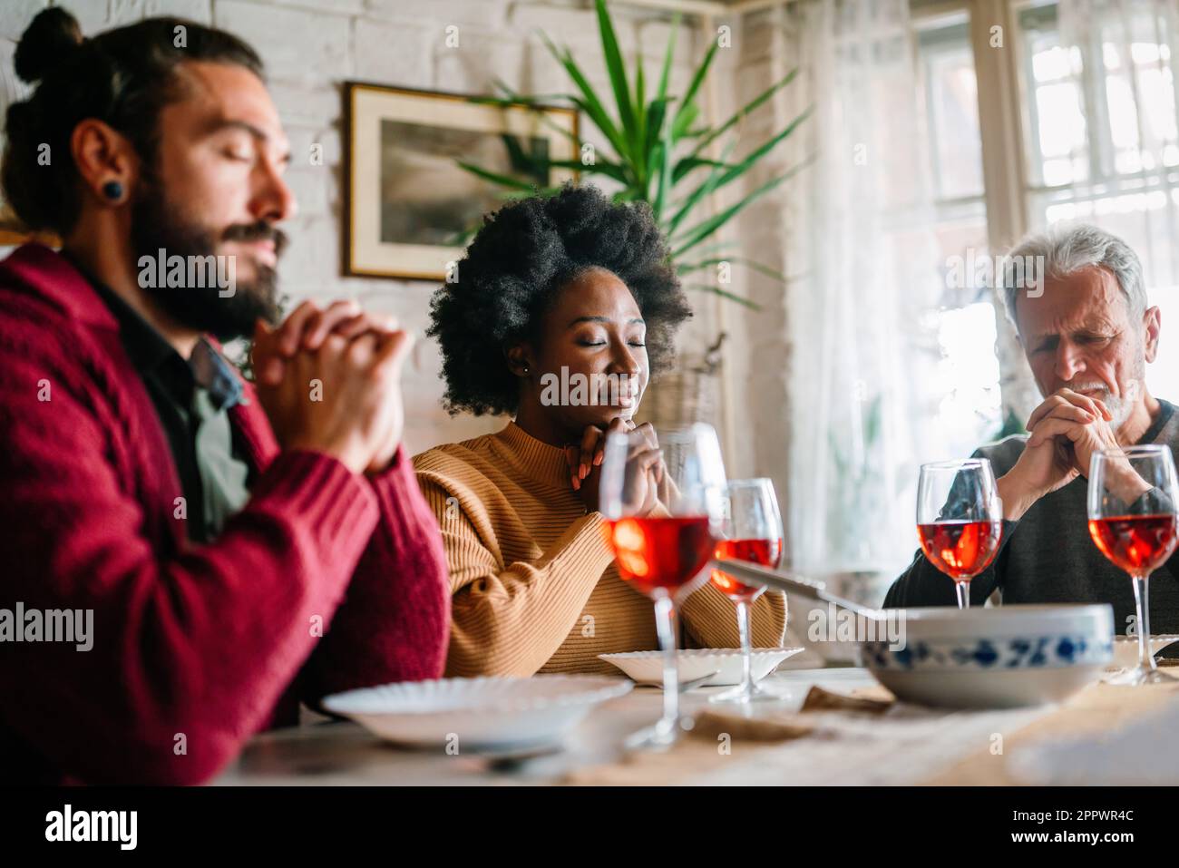Family and religious concept. Group of multiethnic people with food ...