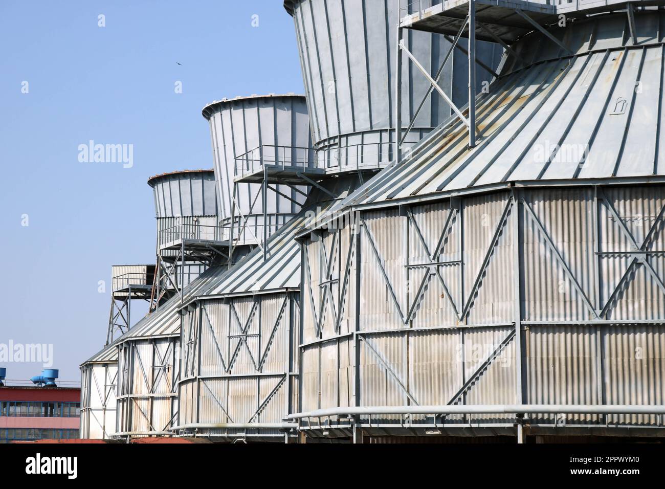 Large gray cooling towers for cooling water are standing in a row ...