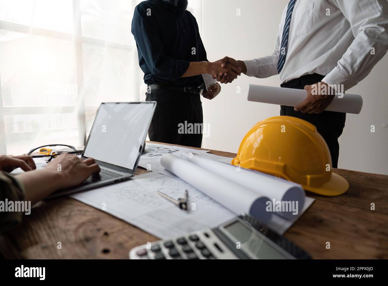 Professional Asian male engineer shaking hands with architect after ...