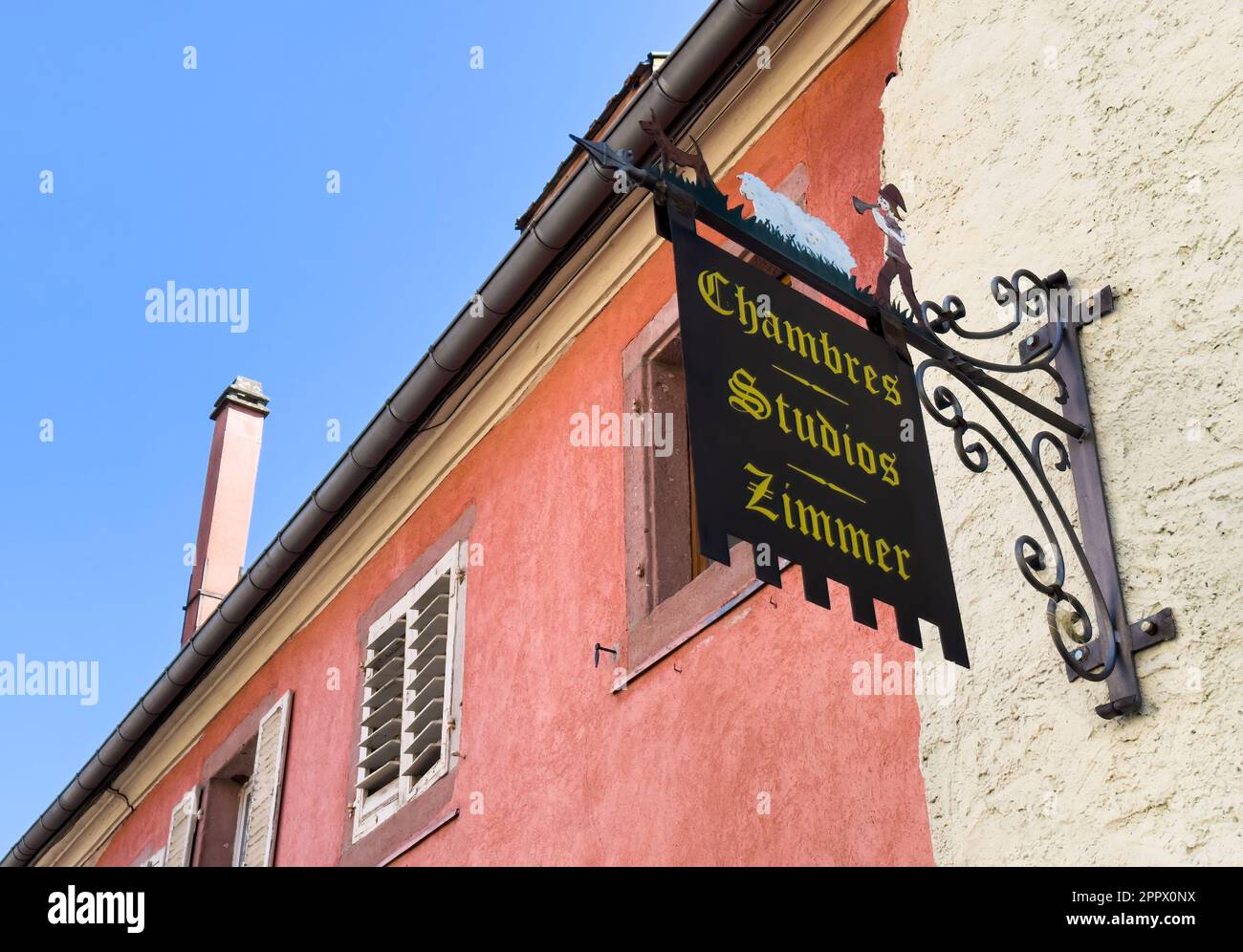 A rustic French auberge hotel with clear signage and room availability ...
