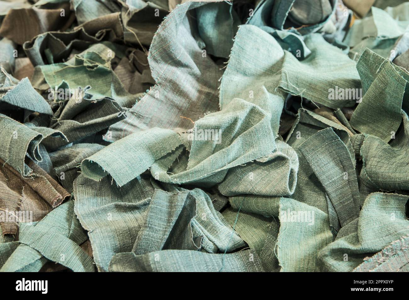 Pile of fabric scraps closeup as textile background Stock Photo - Alamy