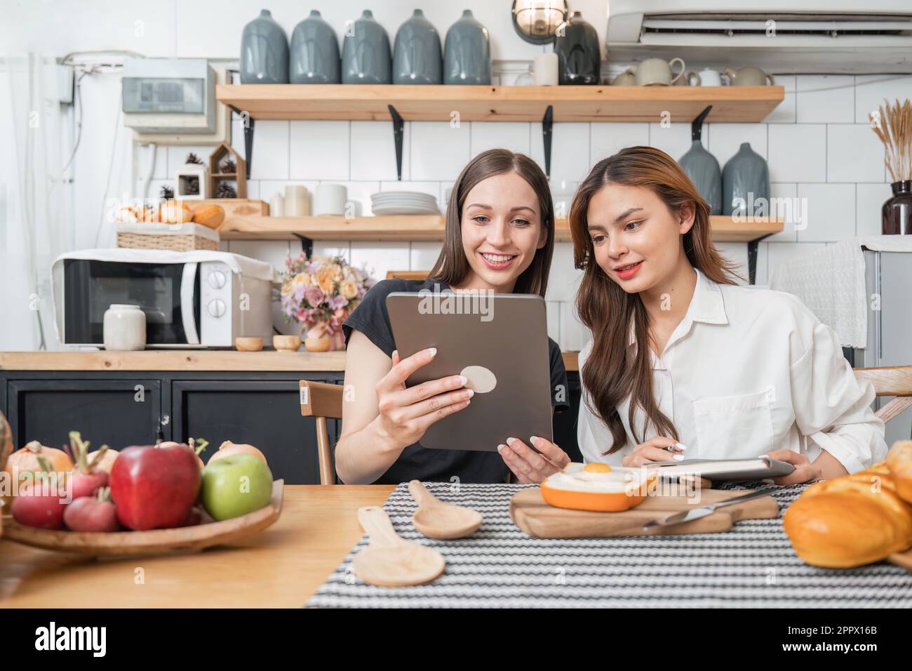girl chef helping each other to cook healthy food of salad from tasty ...