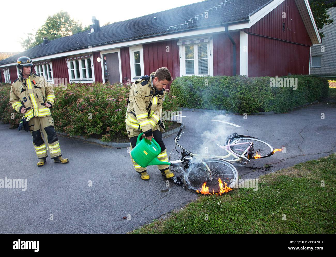 Firefighter from the rescue services extinguishing a fire in a bicycle ...