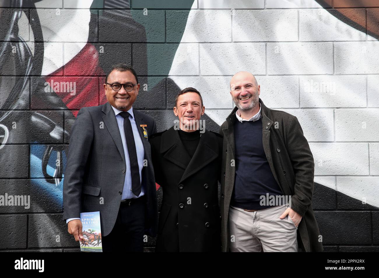 Frankie Dettori (centre) stands in front of his new mural, with the ...