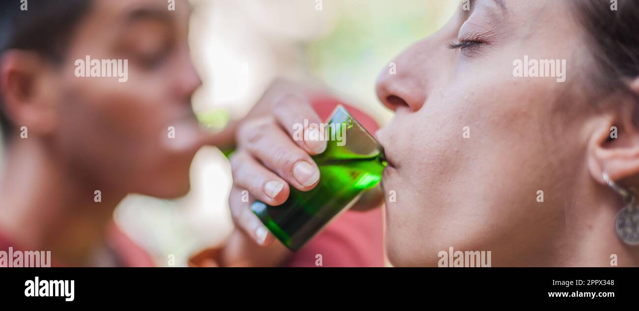 Cheers. Very drunk couple, a boy and a girl, chug shot drink from small ...