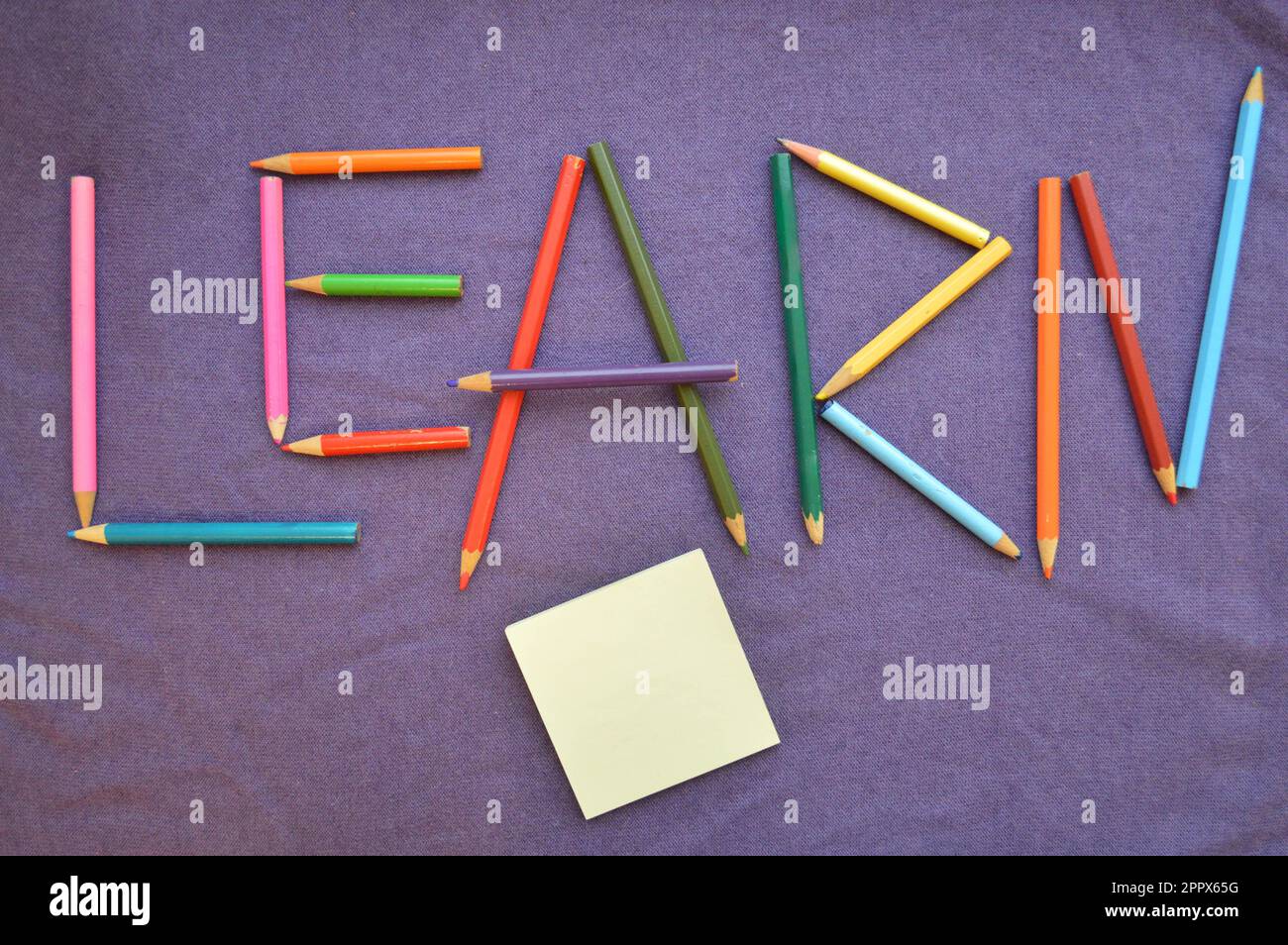 The inscription "learn" is written with colored pencils and a notebook ...