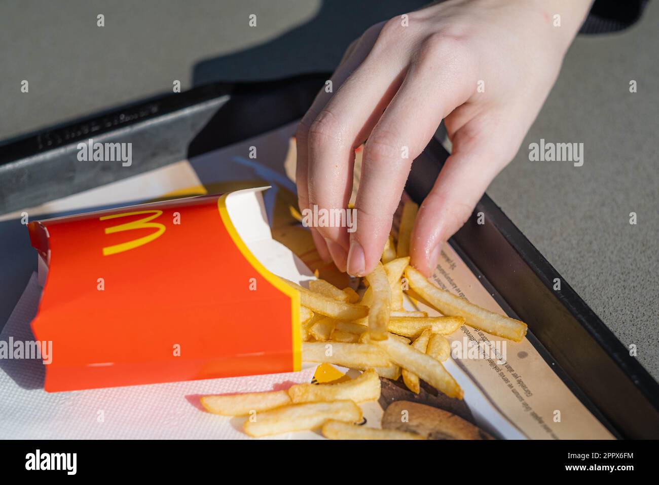 hands taking French fries from packet, boy eating French fries in fast ...
