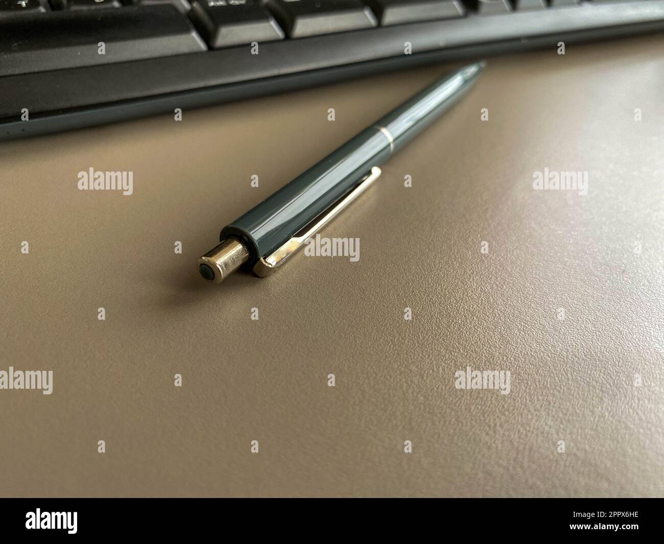 Automatic green ballpoint pen for writing on desktop office desk with ...