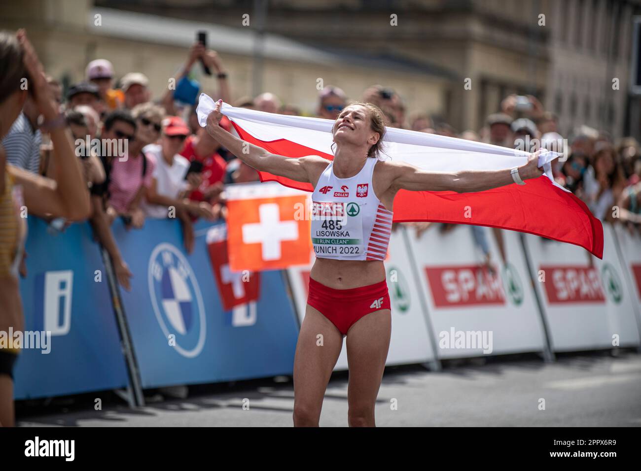 Aleksandra Lisowska with her country's flag after winning the Marathon of the European Athletics ...