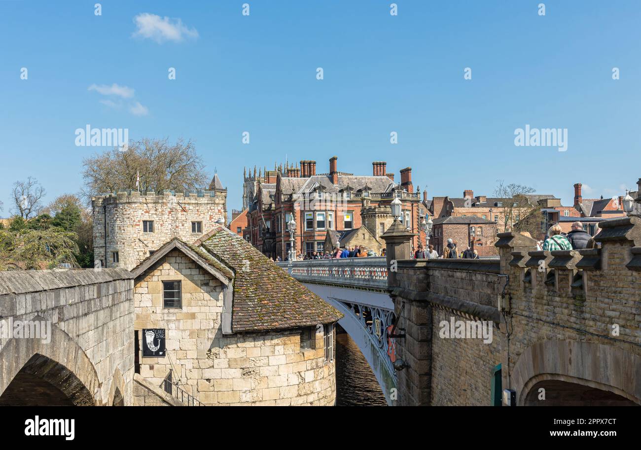 A historic iron bridge full of pedestrians crossing over. Ancient ...