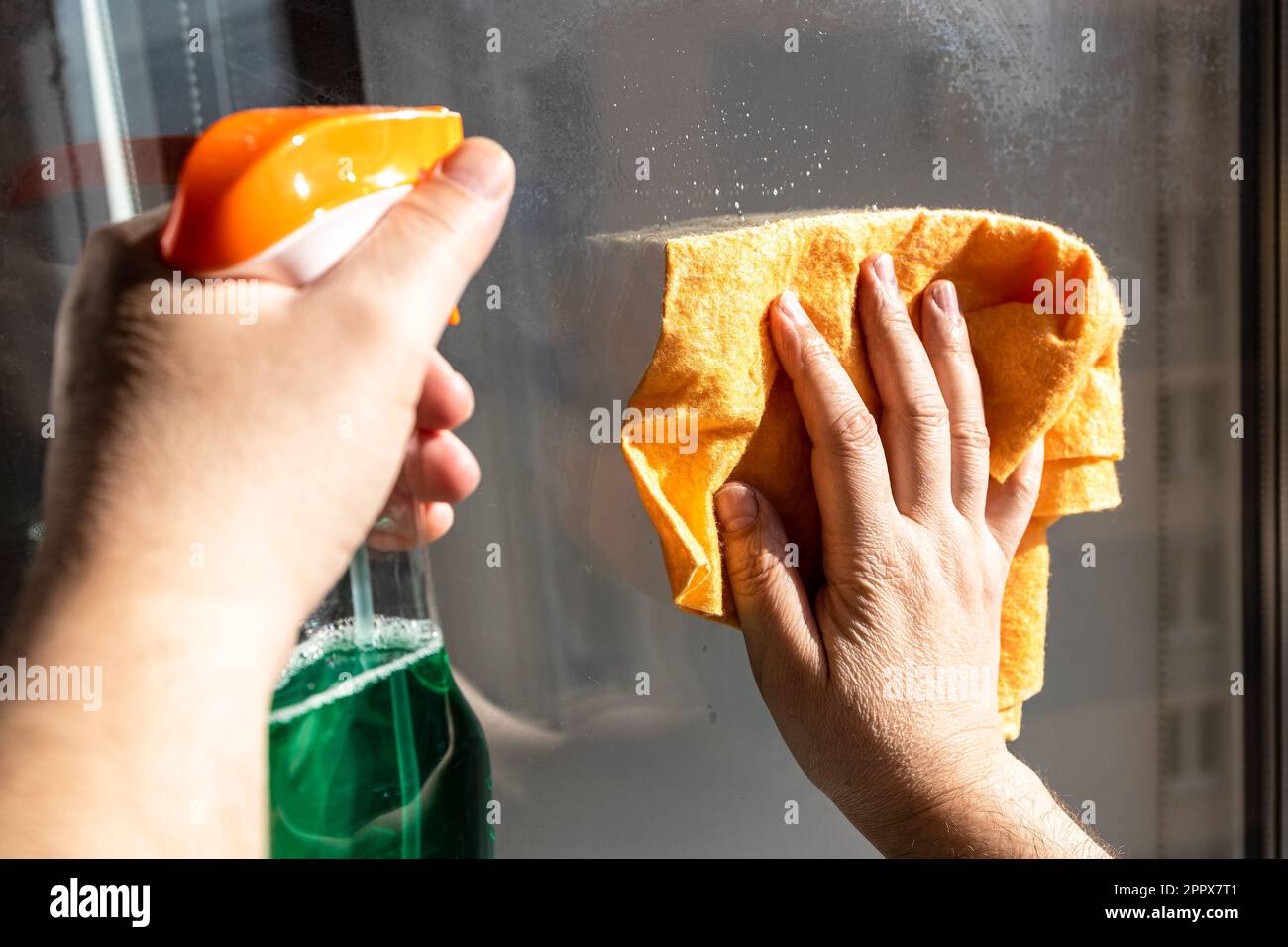 cleaning outdoor home window glass in urban house close up on sunny ...