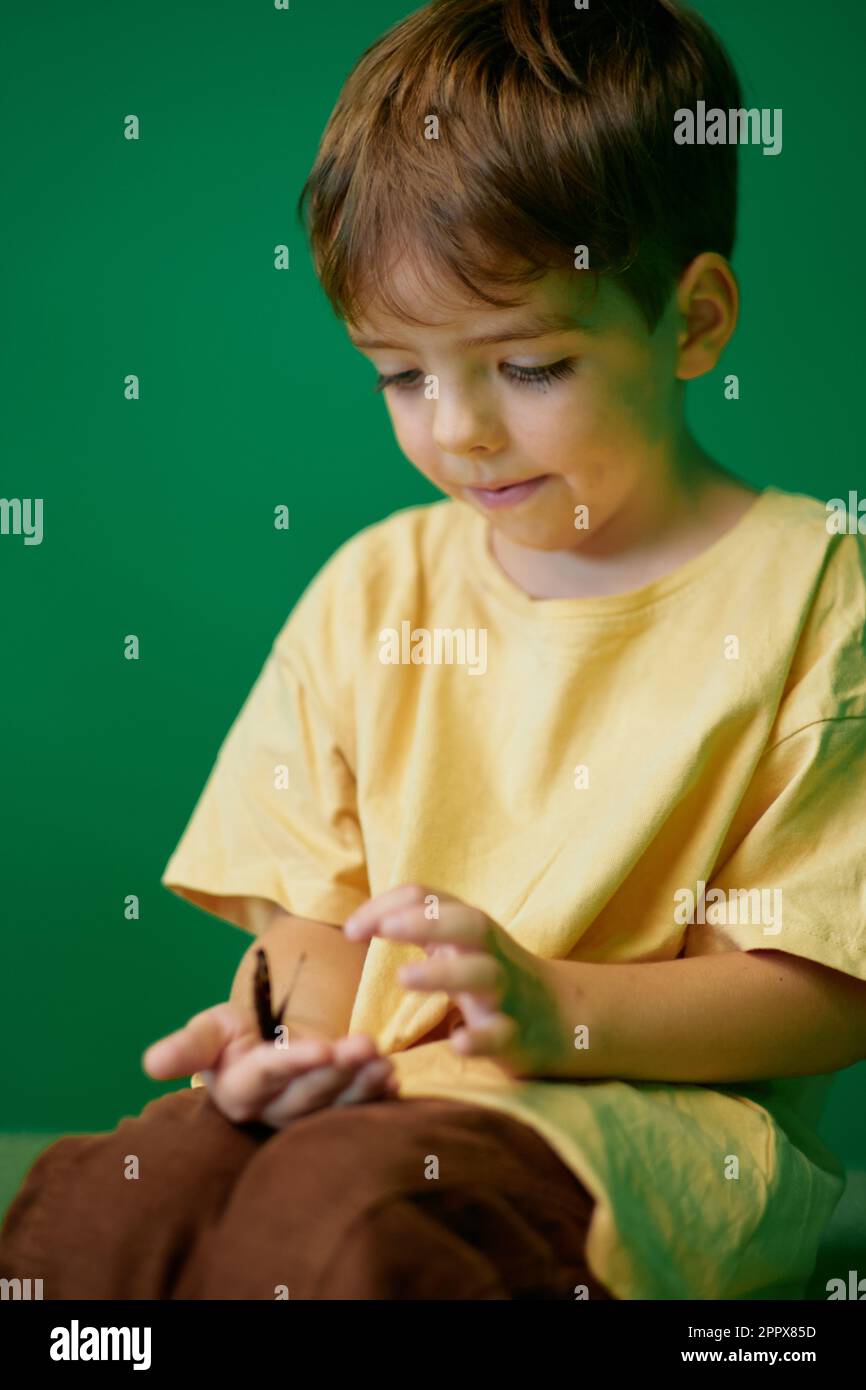 Butterfly concept: small kid enjoying nature at home looking at ...