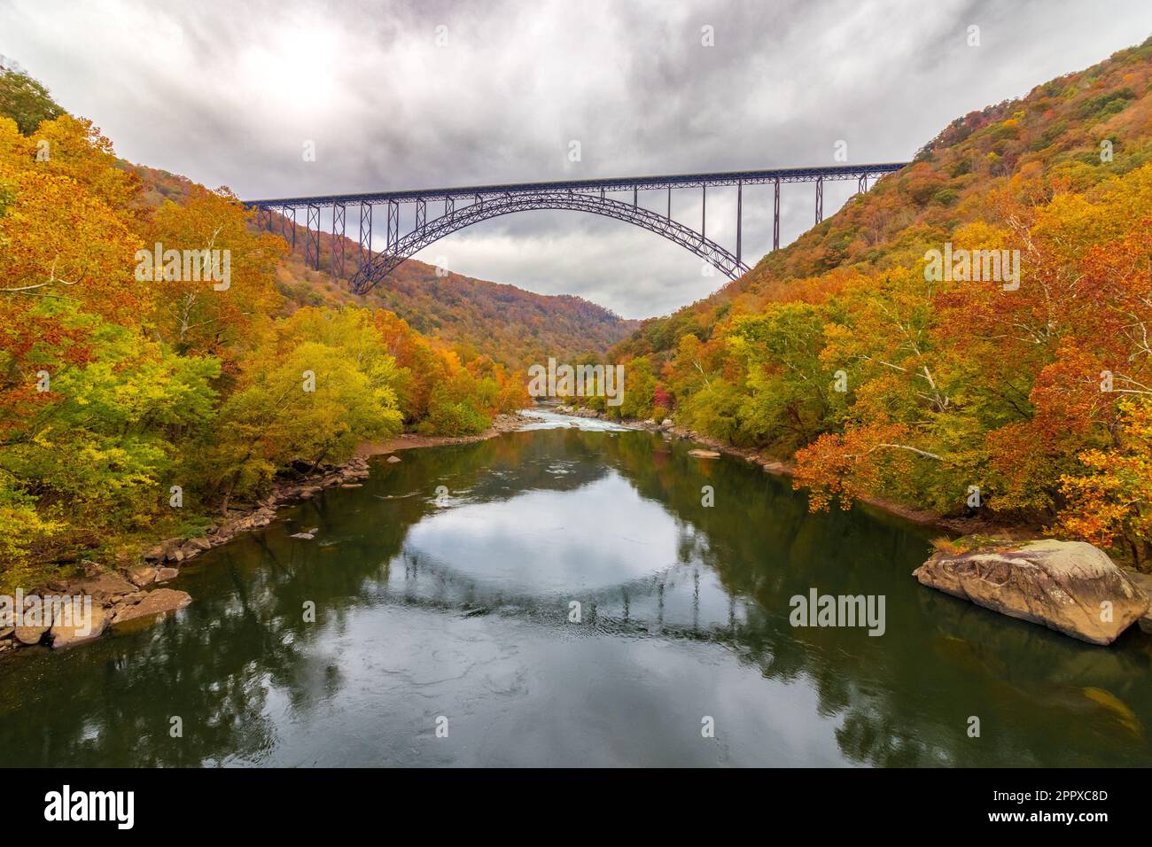 An aerial view of a colorful autumn landscape with a bridge in New ...
