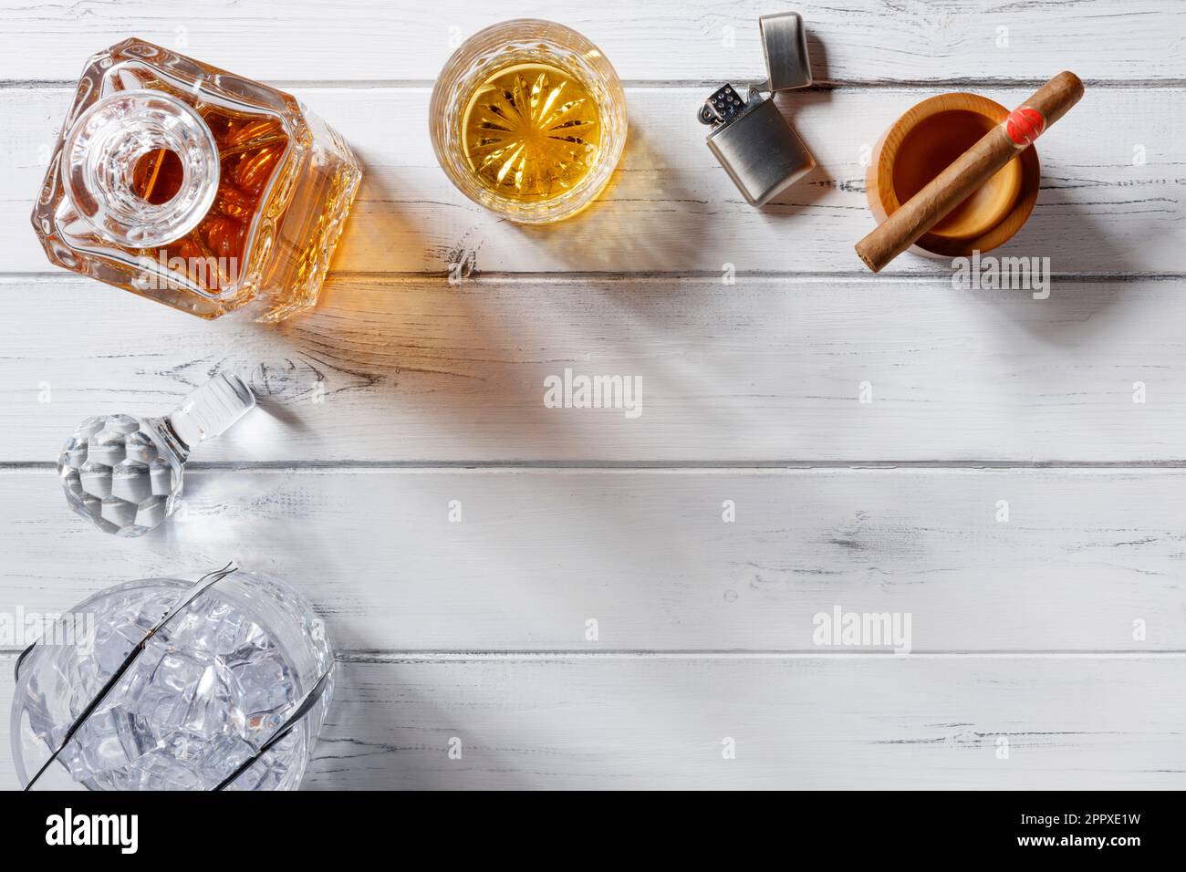 View of a crystal glass and decanter full of golden whisky, ice bucket ...