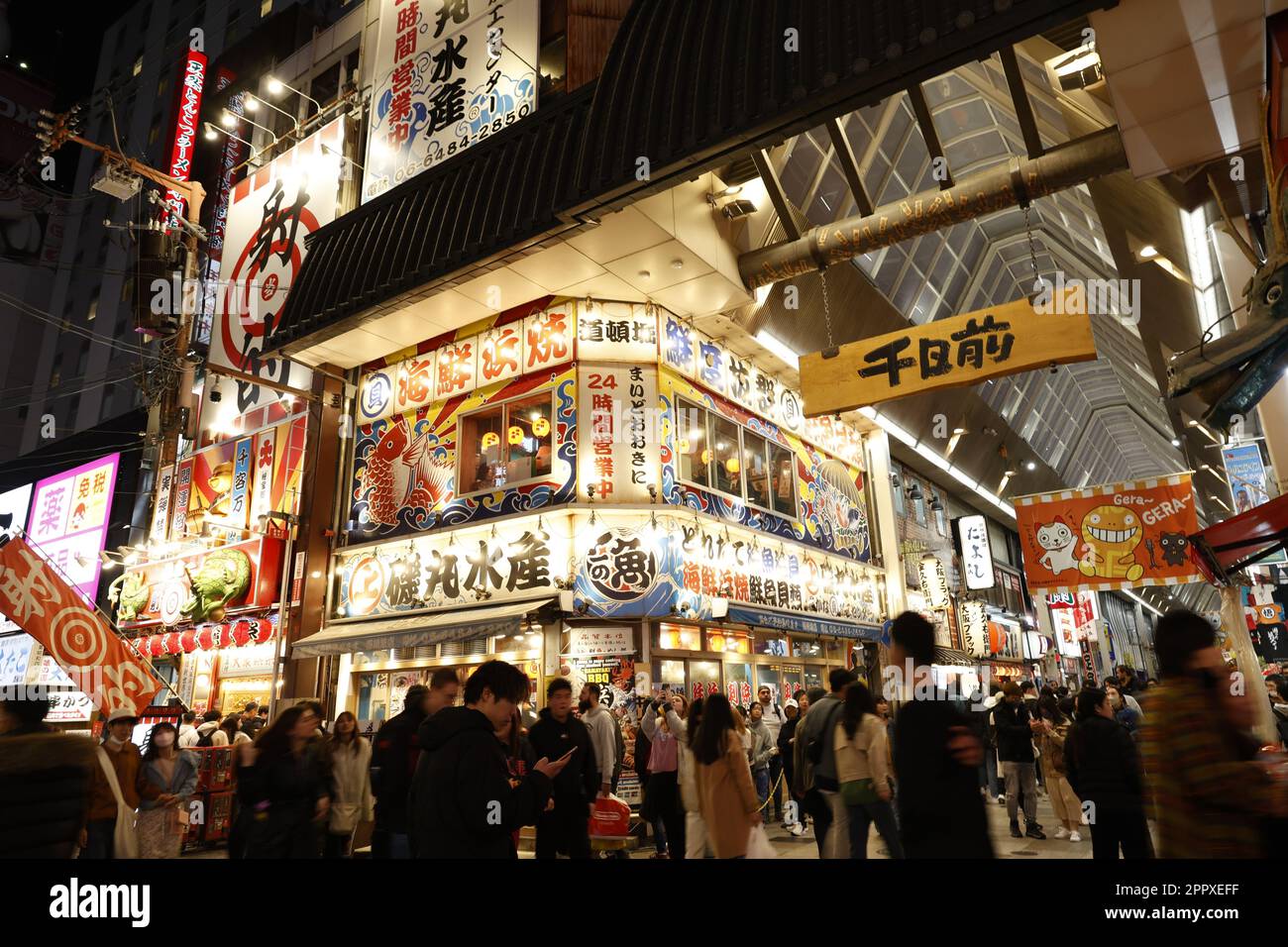 A vibrant street scene in the renowned Dotonbori district of Osaka ...
