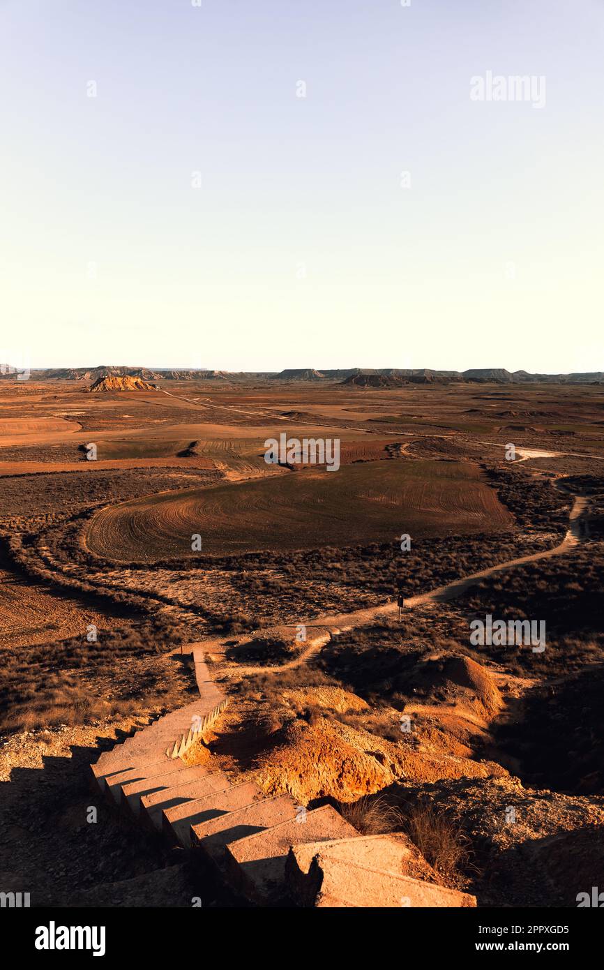 Aerial view of staircases running through dry desert valley with rocky ...