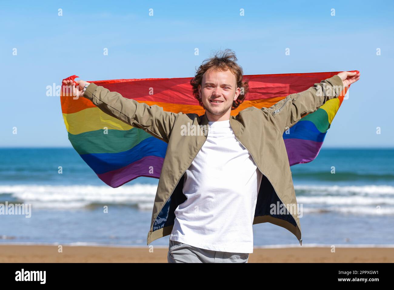 Front view of a delighted post-transition transgender man celebrating ...