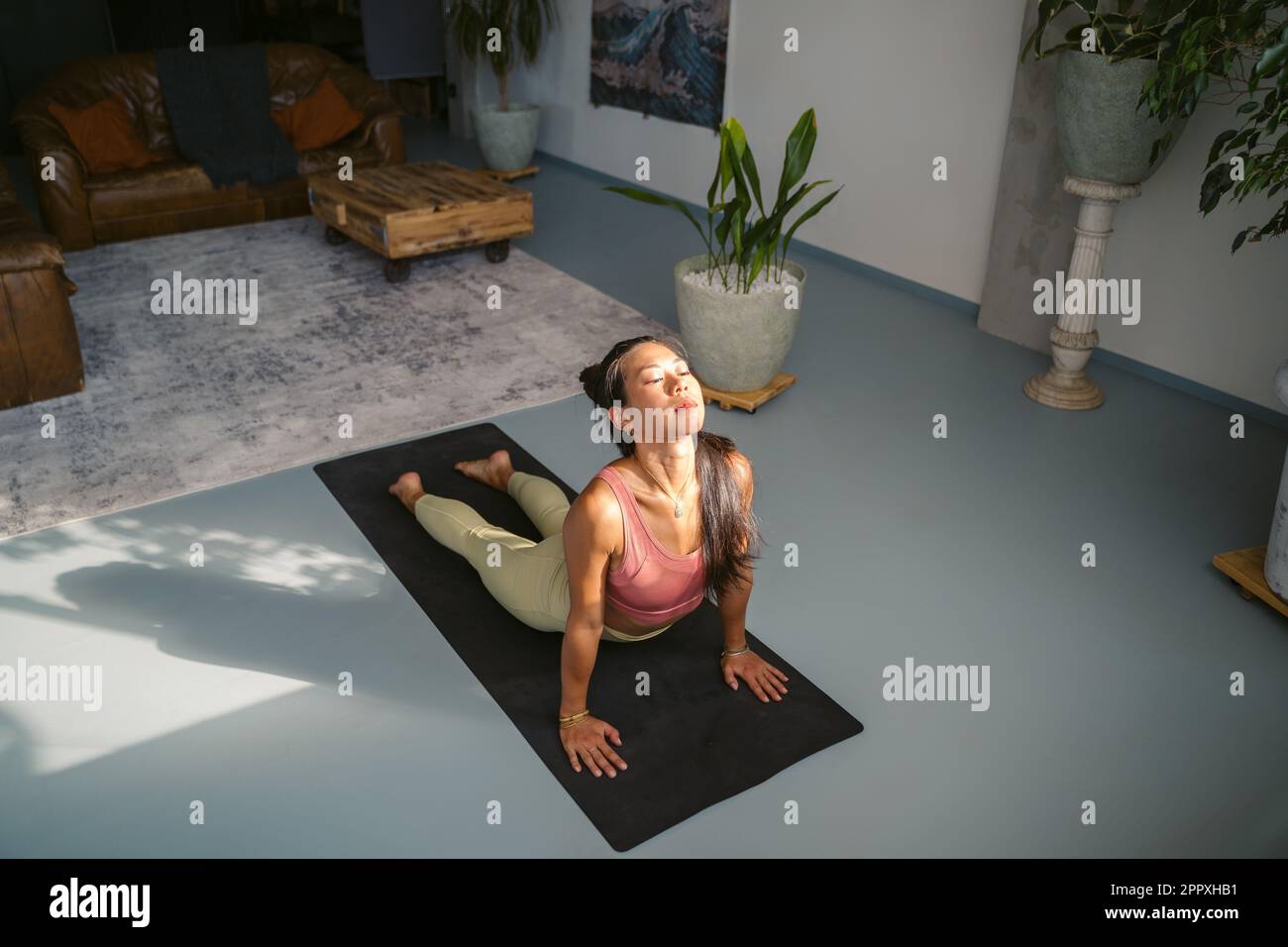 Full body from above of calm young barefoot female in sportswear ...