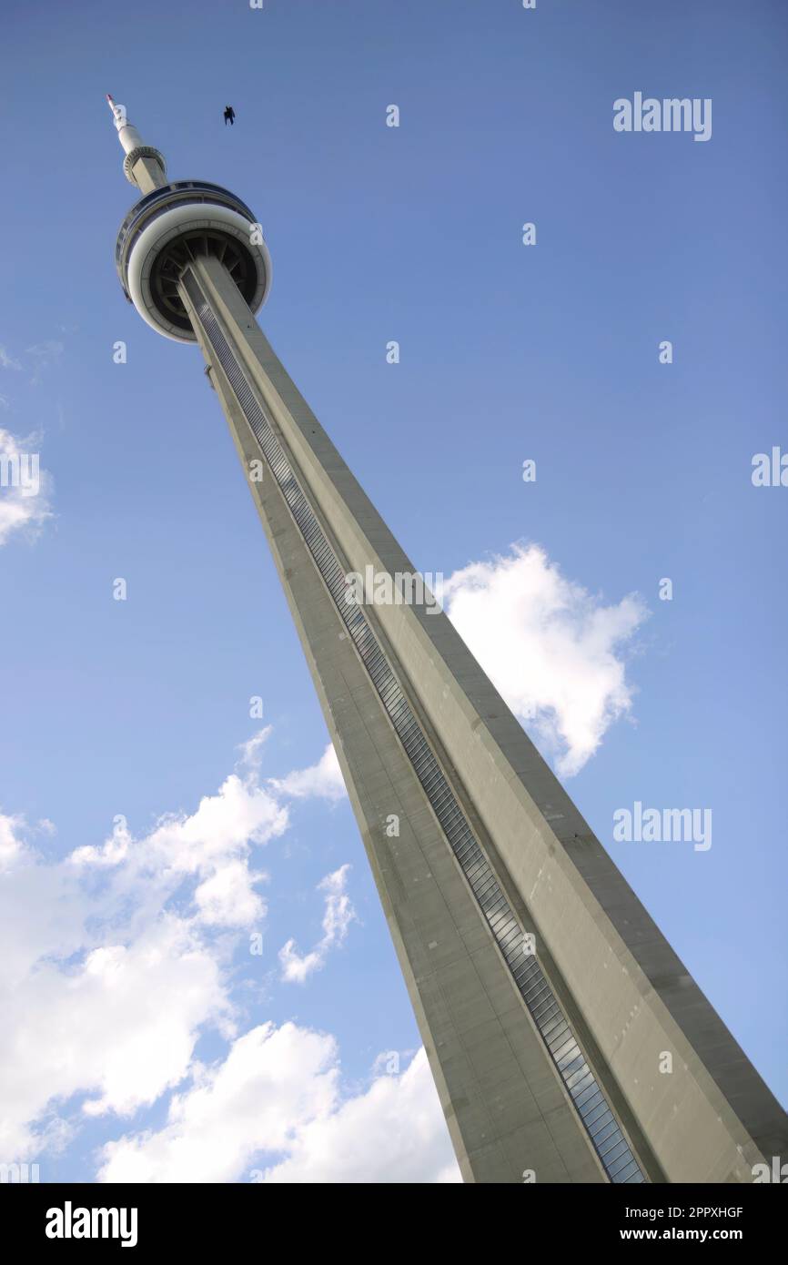 A vertical low angle shot of a majestic skyscraper tower in the vibrant ...