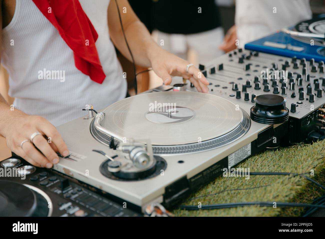 From above cropped anonymous DJ playing music on mixing console during ...