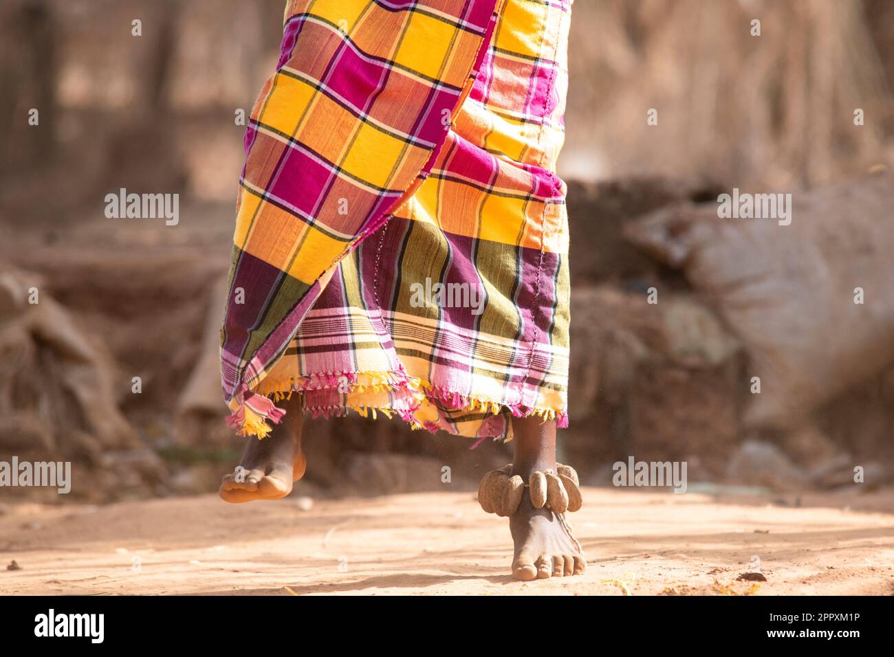 Crop unrecognizable female African wrapped in colorful checkered ...