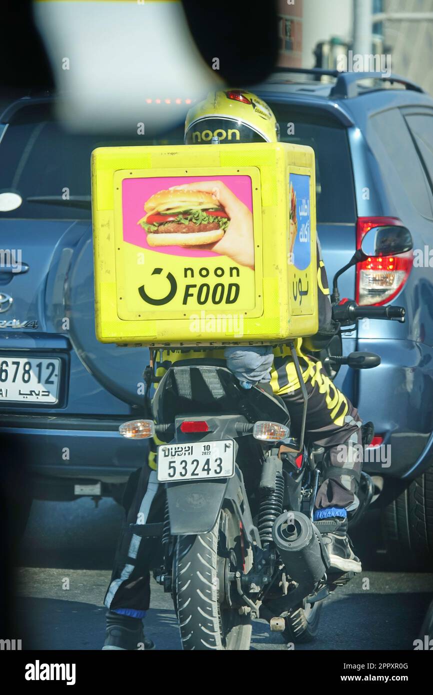Motorcycle food delivery workers at work in the street. Dubai, United ...