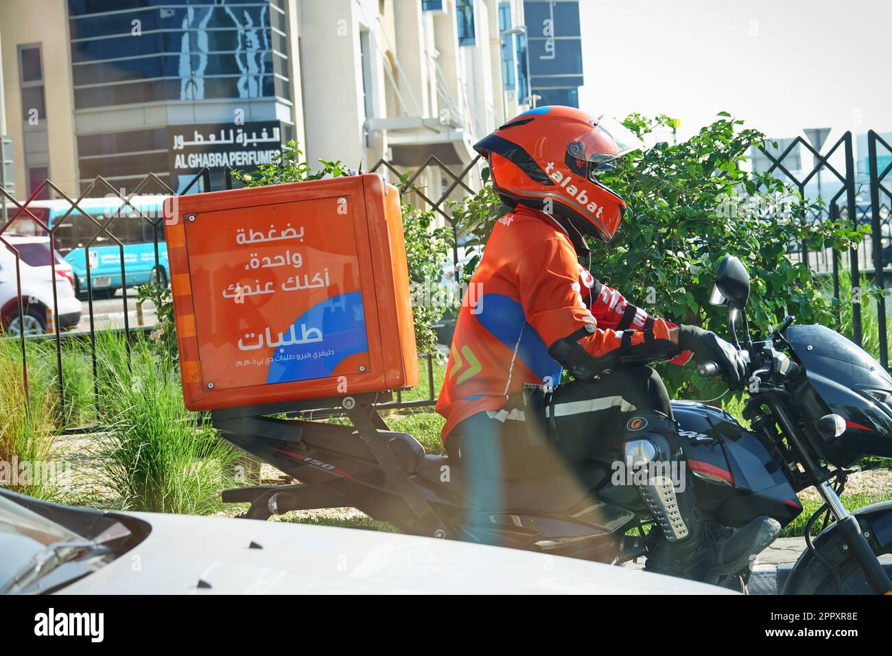 Motorcycle food delivery workers at work in the street. Dubai, United ...