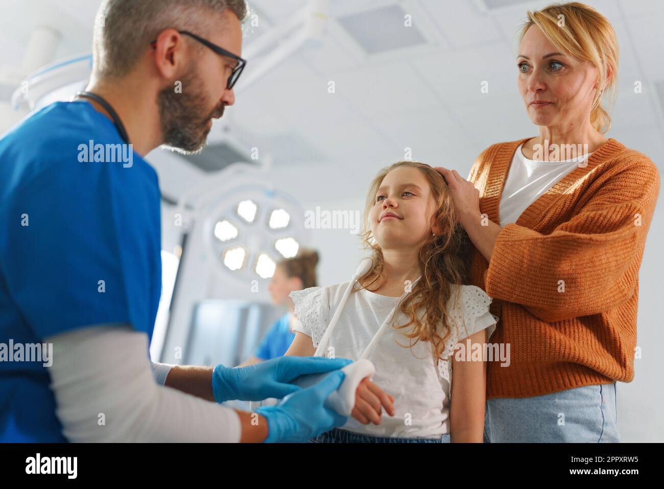 Mature doctor giving gypsum to little girl Stock Photo - Alamy