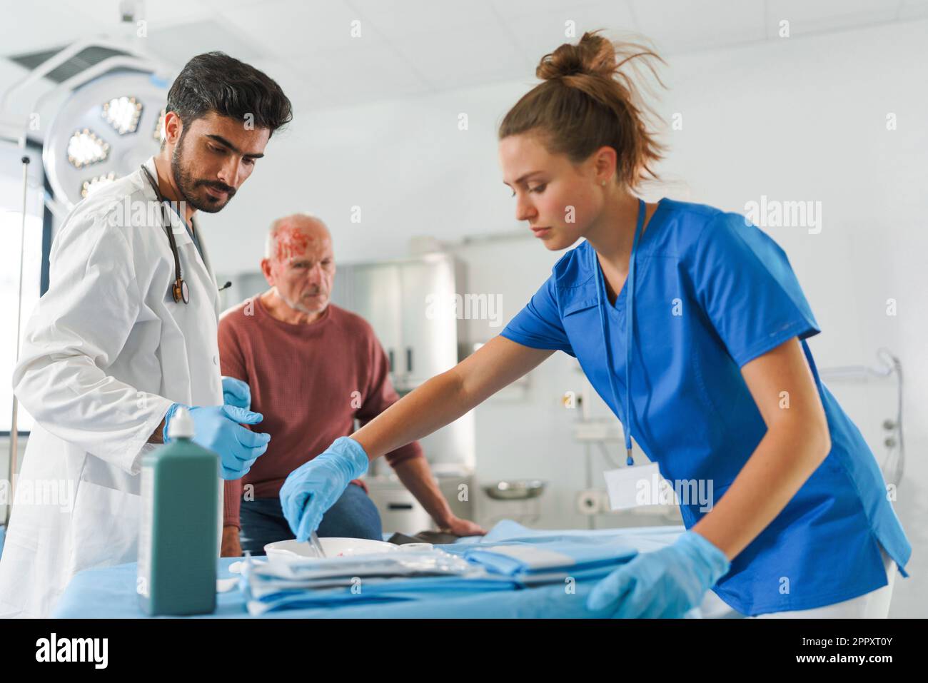 Young doctor and nurse treating injury of senior man Stock Photo - Alamy
