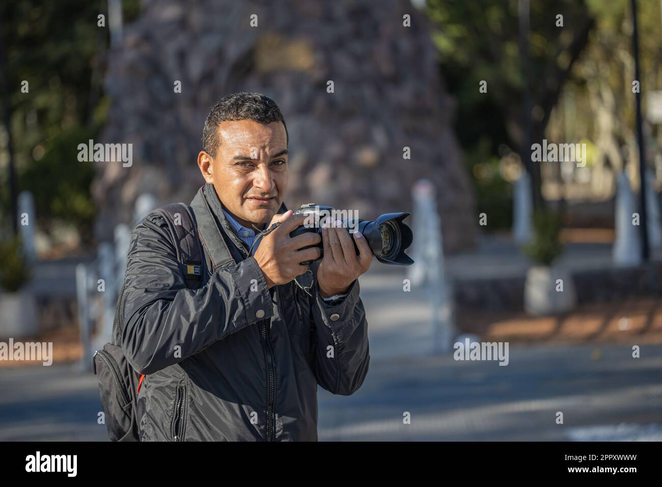 Portrait of a photojournalist working on the street Stock Photo - Alamy