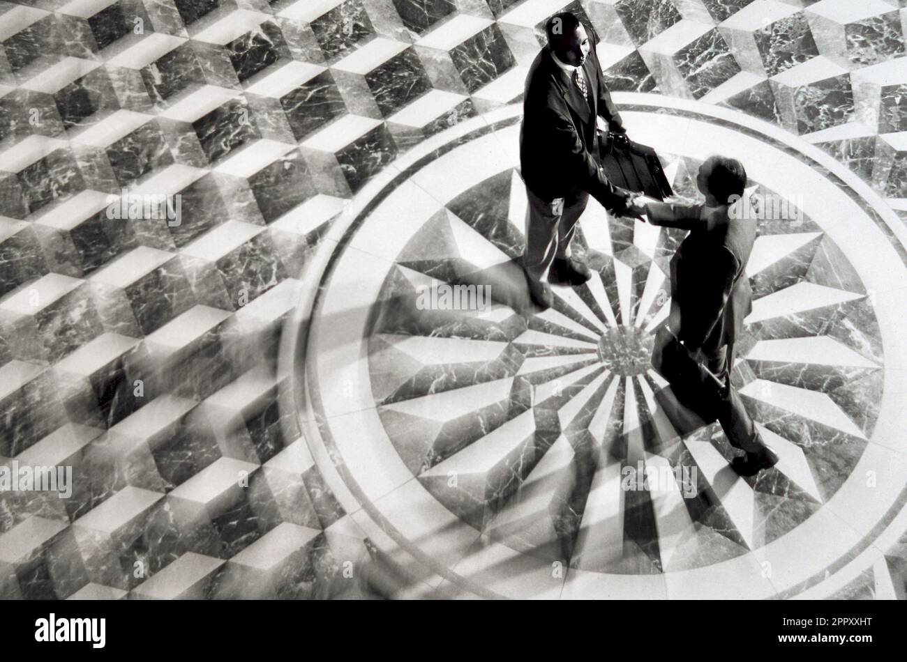 Overhead view of an African-American and Caucasian businessmen shaking ...