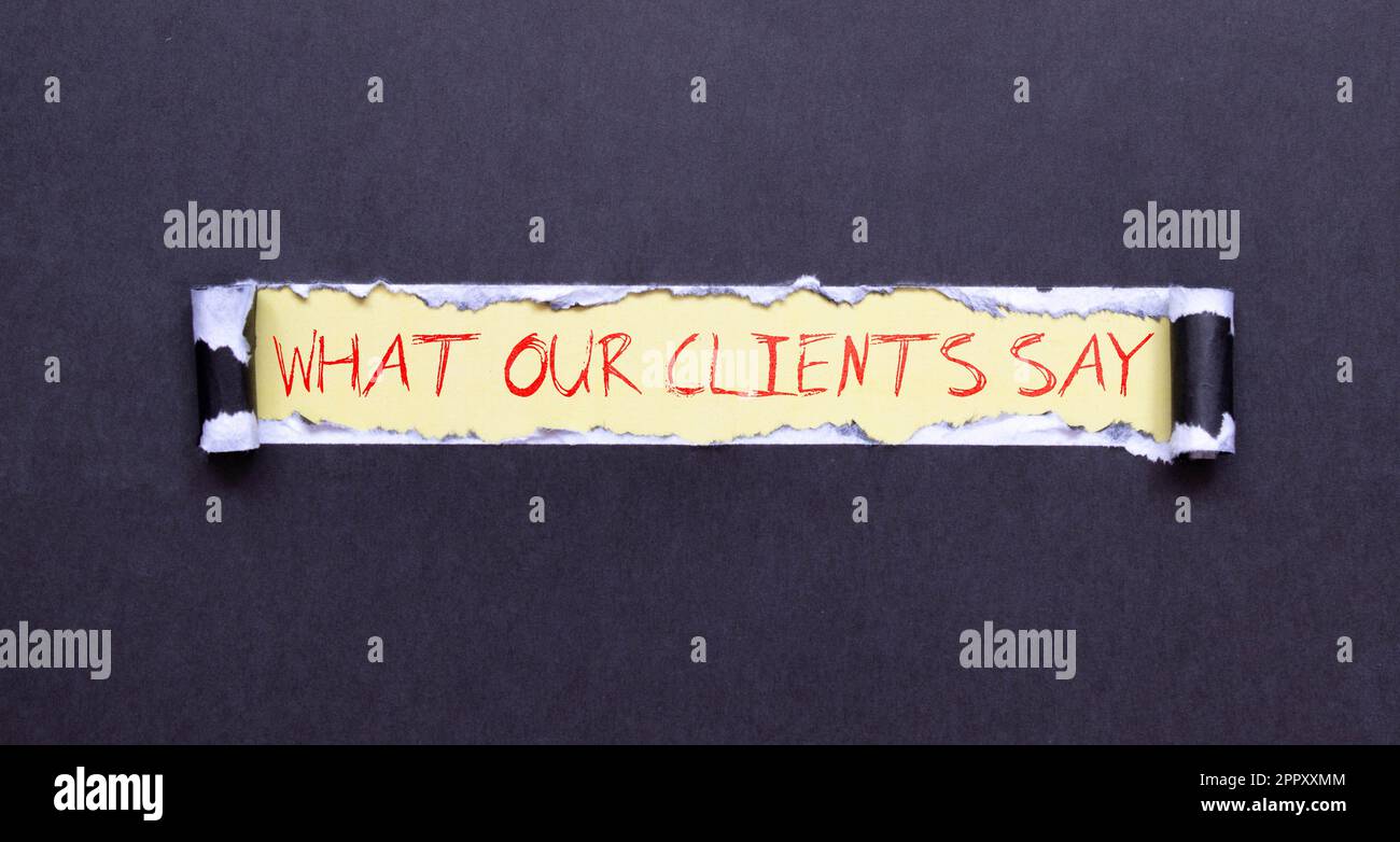 What Our Clients Say statement on paper note pad. Office desk with ...