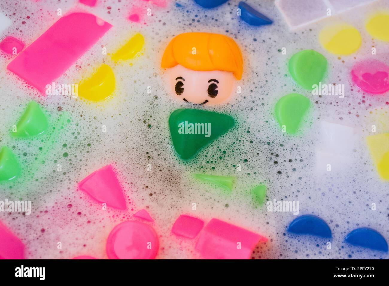 Washing of children toys, plastic building blocks with figurines. A ...