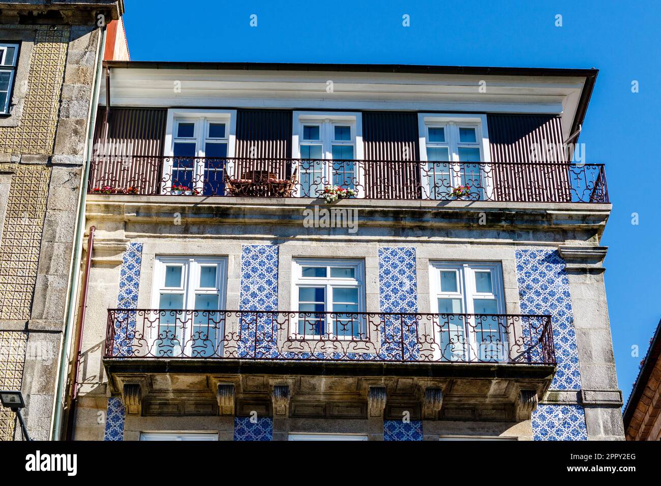 Facade of a Portuguese apartment building with blue tiles and balconies ...