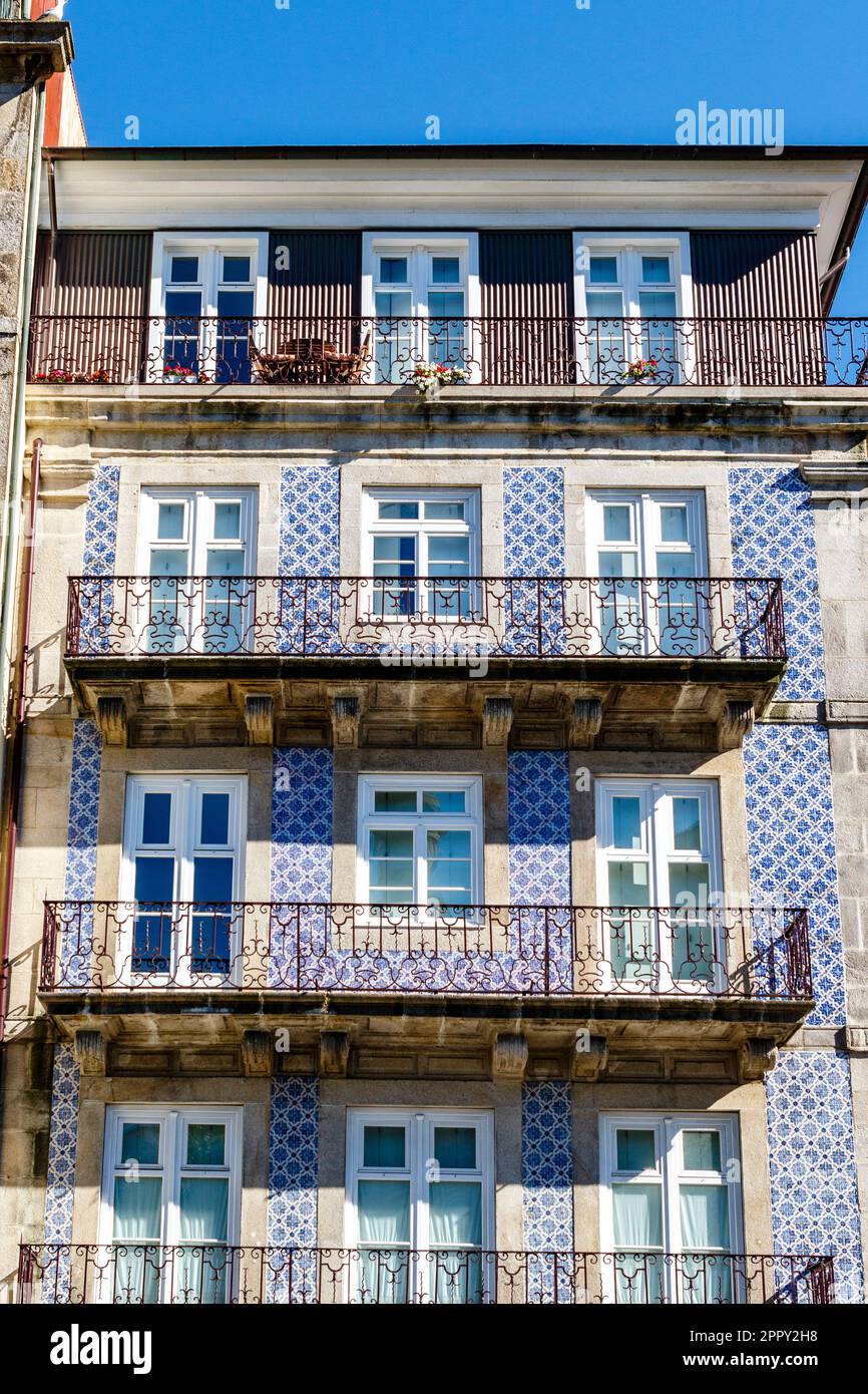 Facade of a Portuguese apartment building with blue tiles and balconies ...