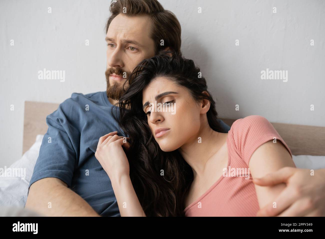 Woman man couple bed hug sad hi-res stock photography and images - Alamy