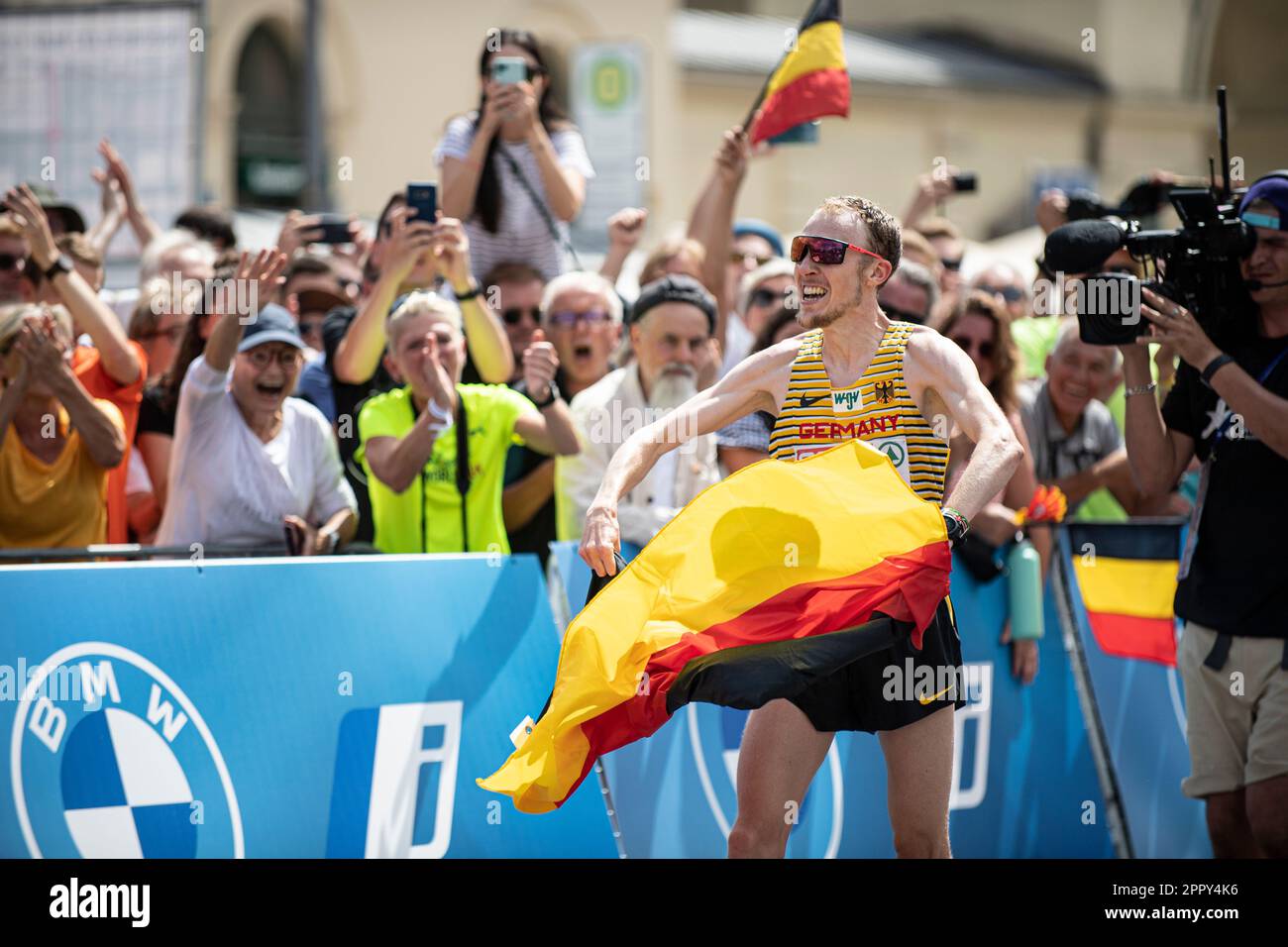 Richard Ringer with his country's flag celebrating his victory in the ...