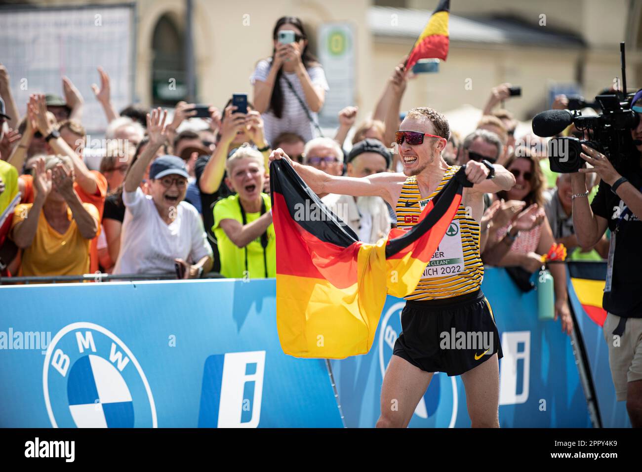 Richard Ringer with his country's flag celebrating his victory in the ...