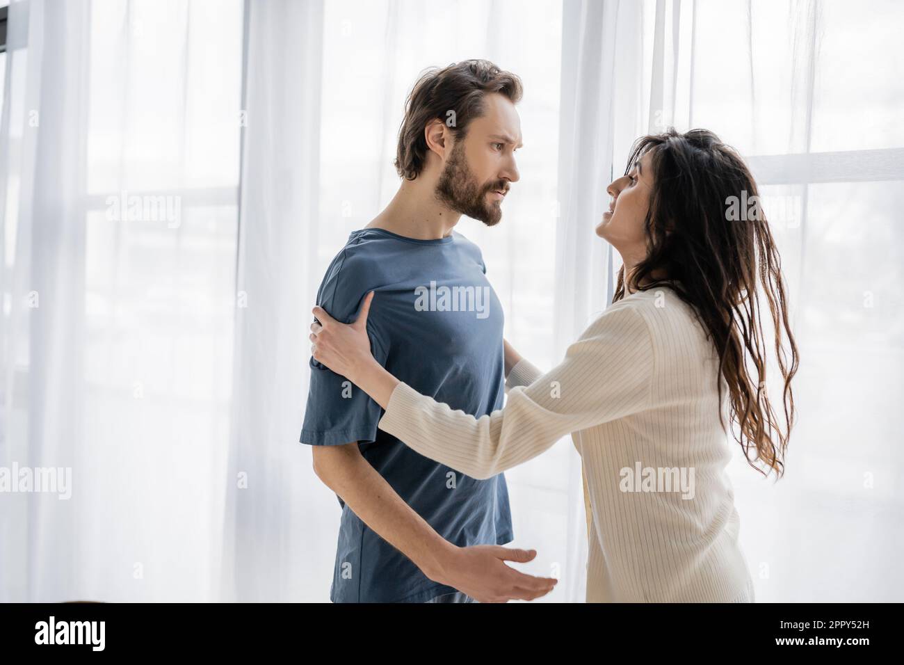 Aggressive man looking at frightened girlfriend during relationship ...