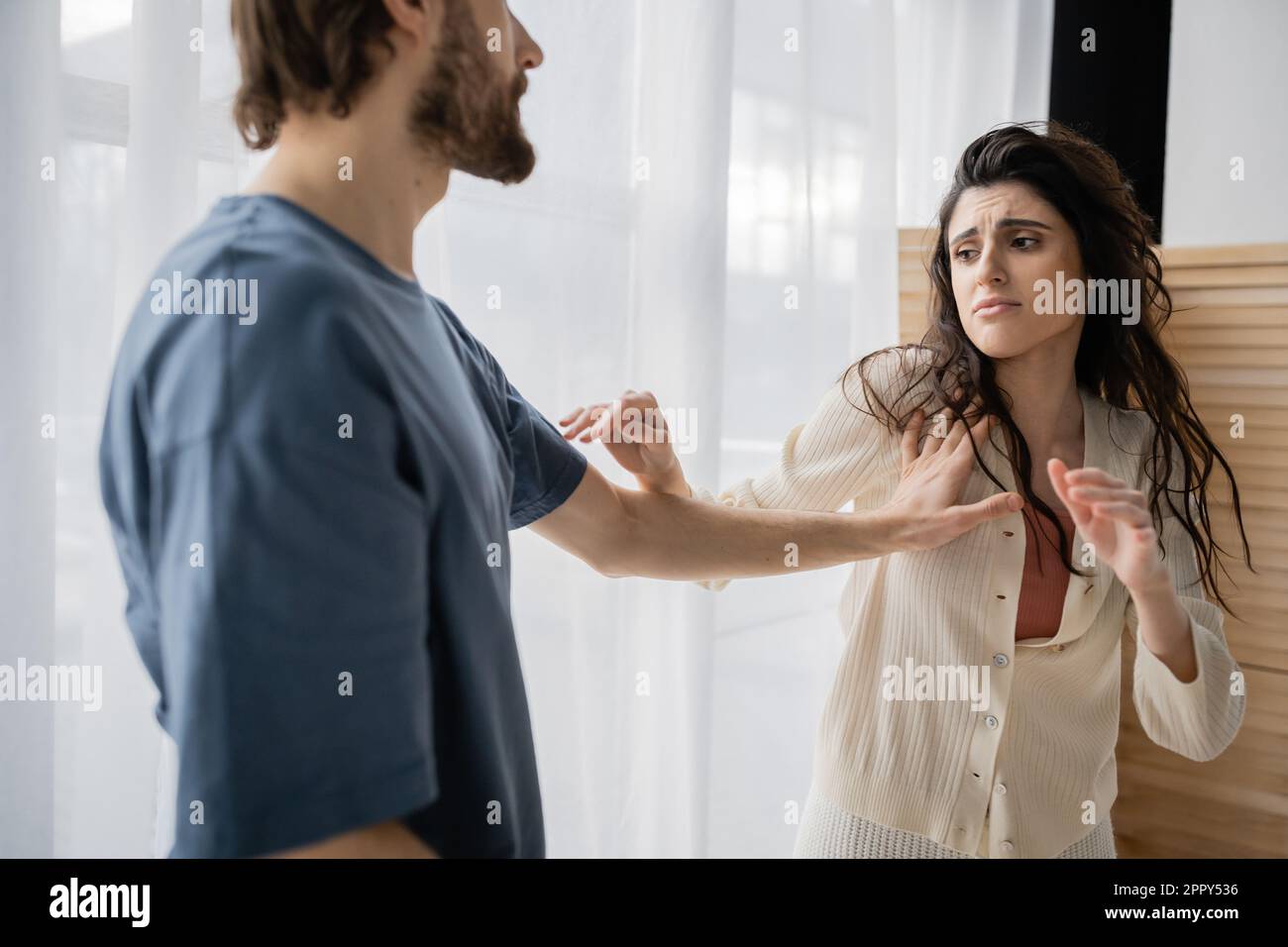 Afraid woman standing near abusive boyfriend during relationship ...