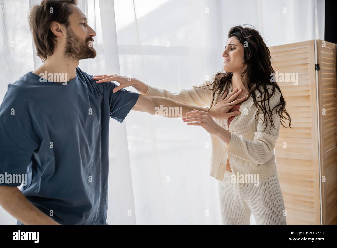 Abusive man pushing scared girlfriend in pajama at home,stock image ...